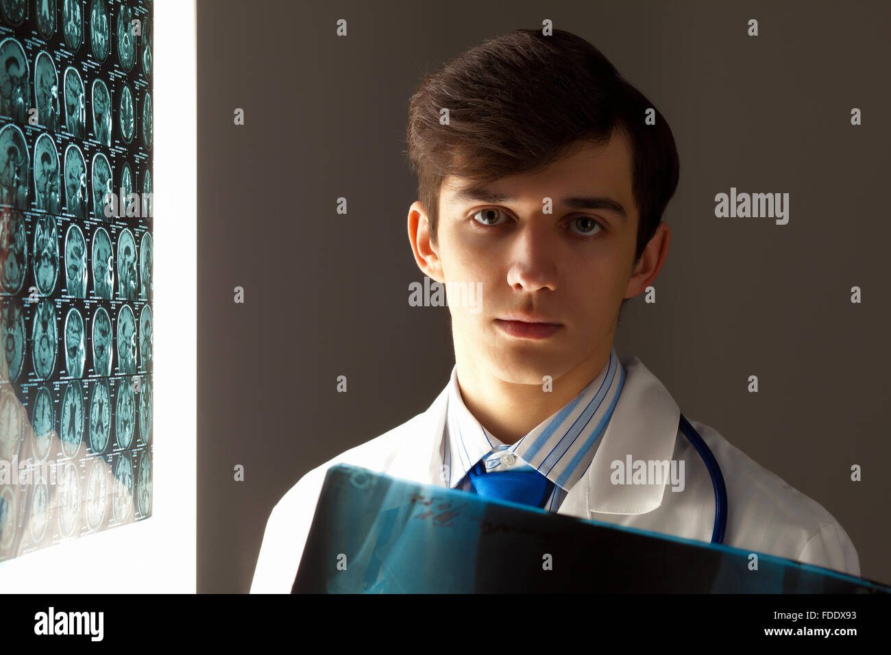Image of male doctor holding x-ray results Stock Photo - Alamy