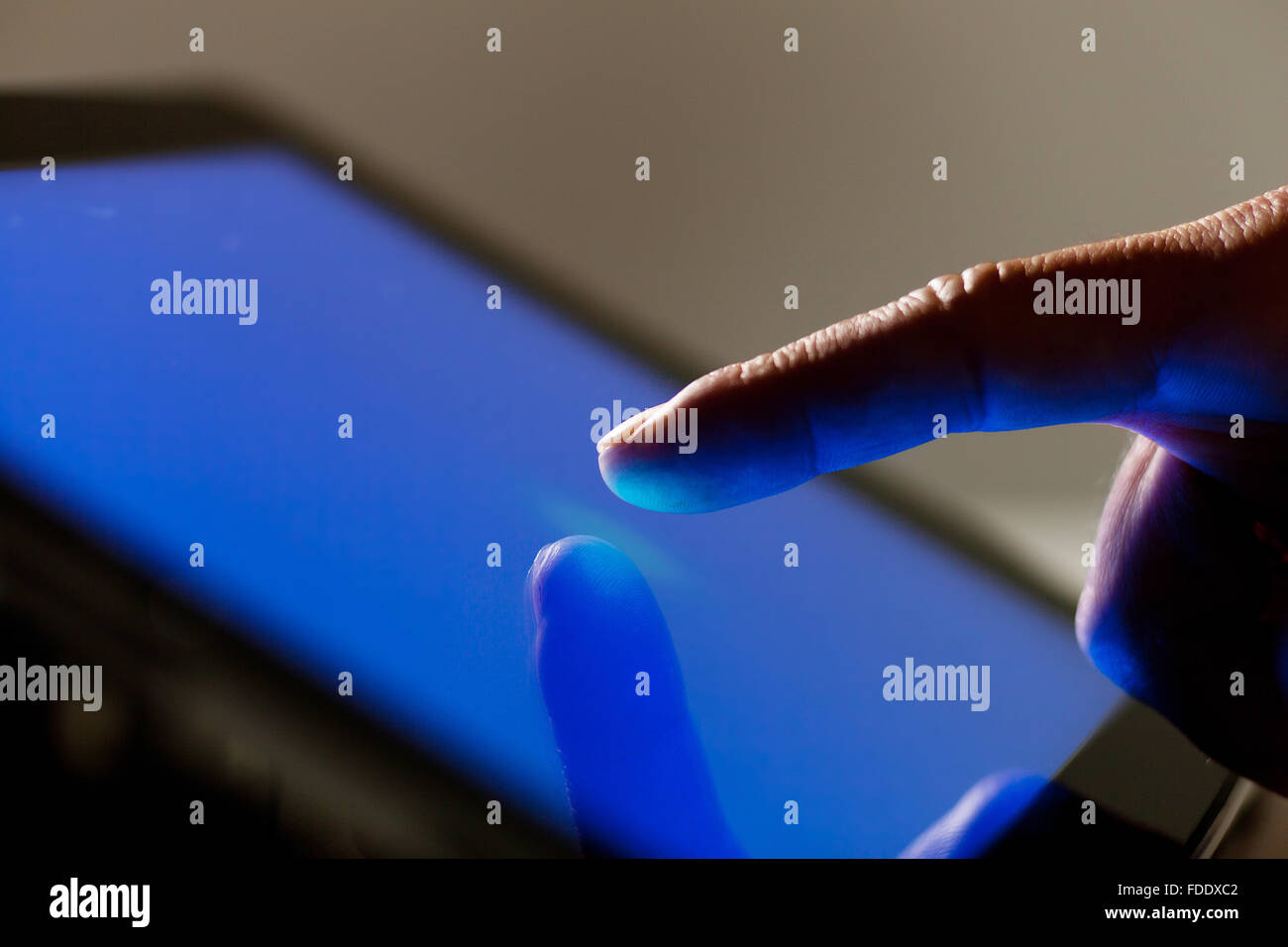 Close-up image of finger touching blue screen Stock Photo - Alamy