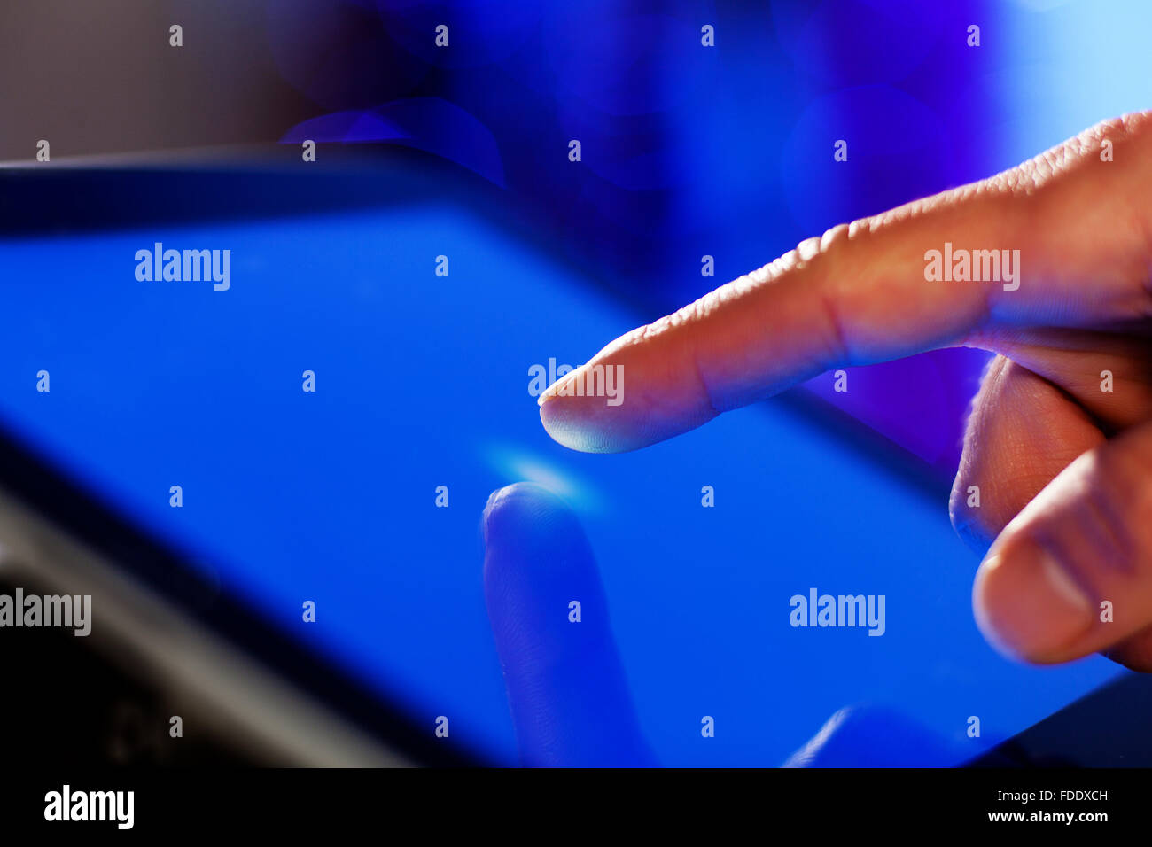 Close-up image of finger touching blue screen Stock Photo - Alamy