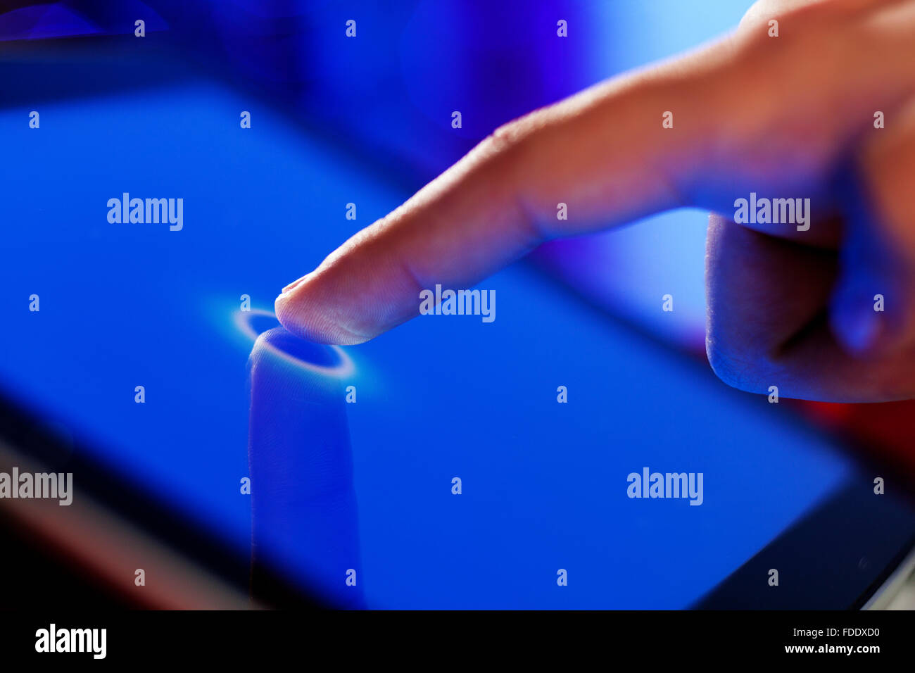 Close-up image of finger touching blue screen Stock Photo - Alamy