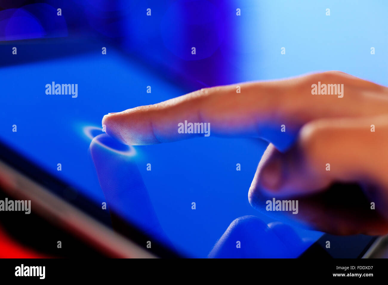 Close-up image of finger touching blue screen Stock Photo - Alamy