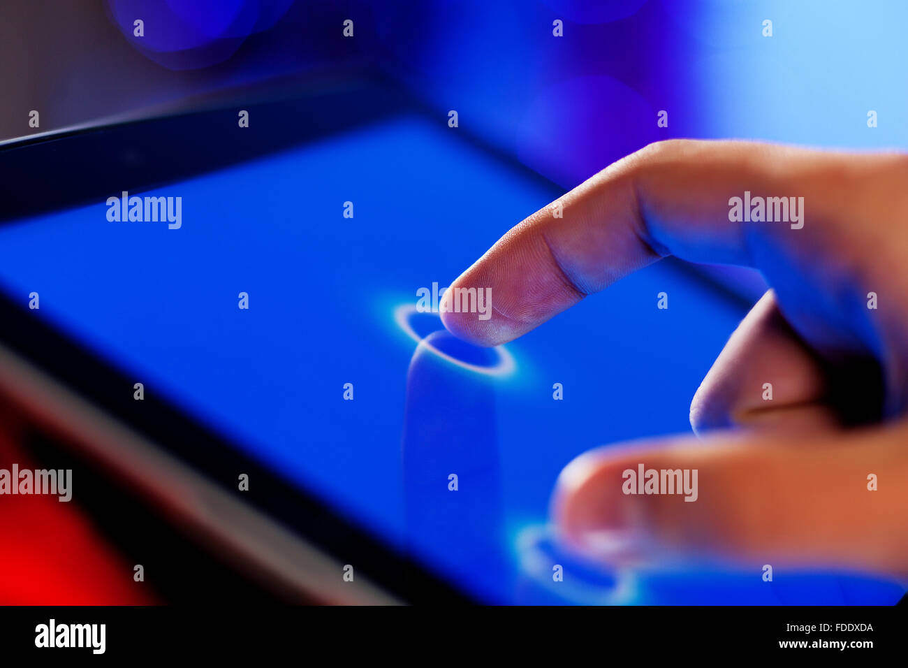 Close-up image of finger touching blue screen Stock Photo - Alamy