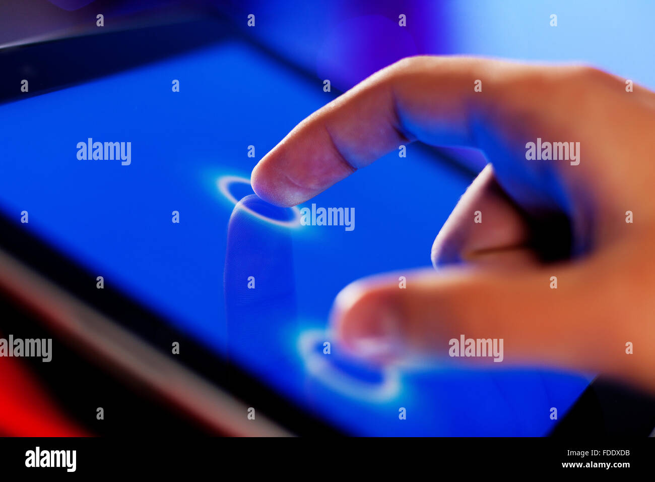 Close-up image of finger touching blue screen Stock Photo - Alamy