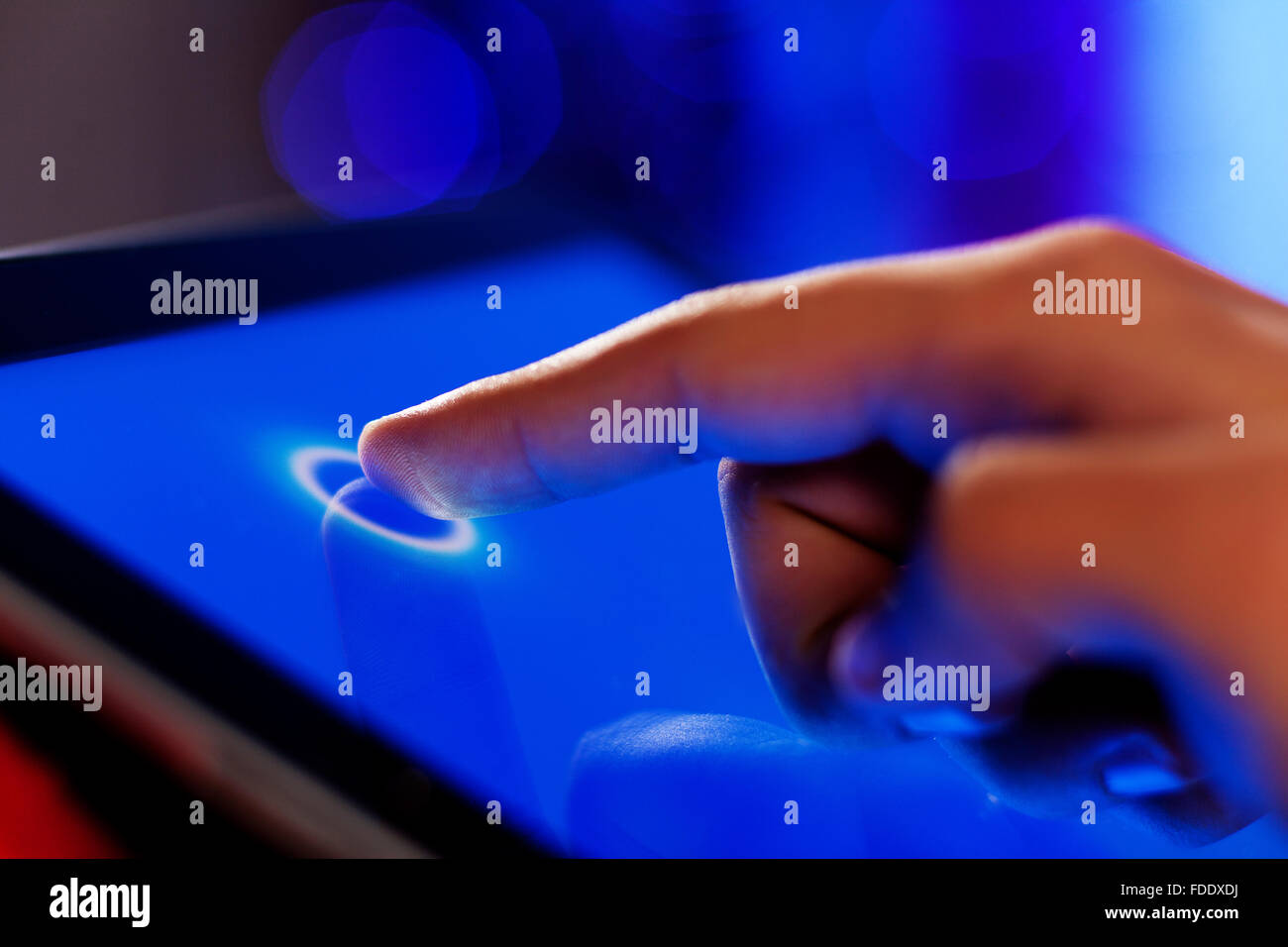 Close-up image of finger touching blue screen Stock Photo - Alamy