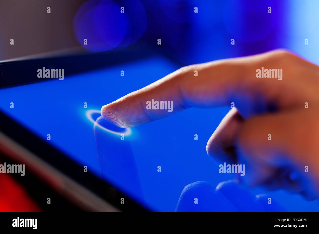 Close-up image of finger touching blue screen Stock Photo - Alamy