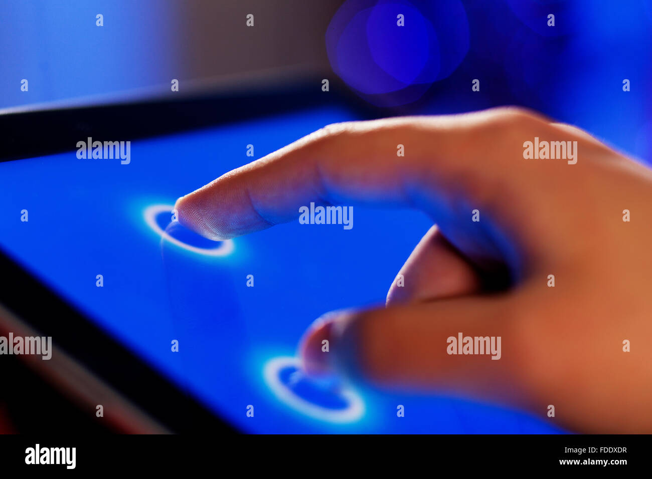 Close-up image of finger touching blue screen Stock Photo - Alamy