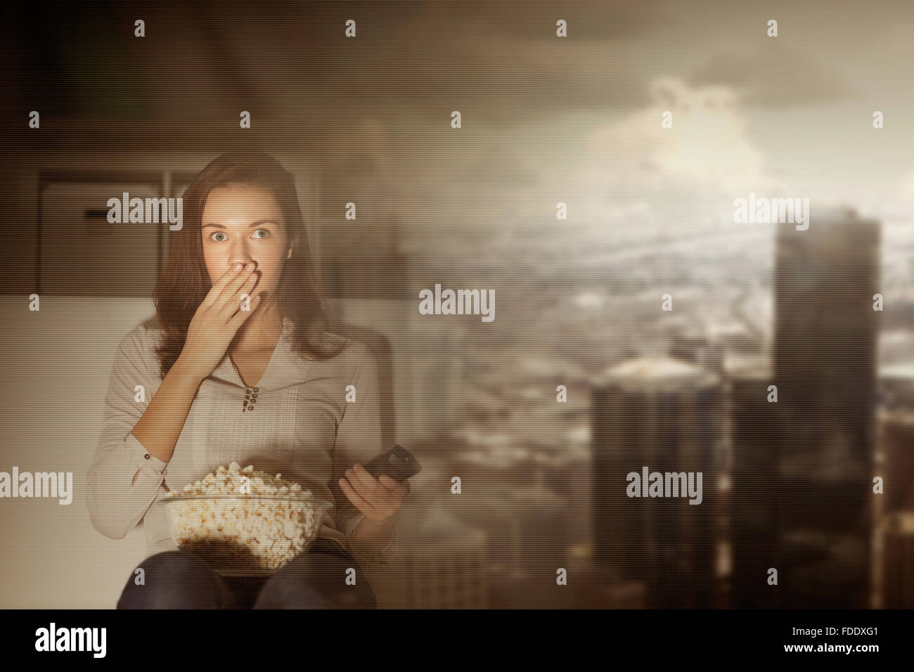 Scared young woman with click and popcorn watching TV Stock Photo - Alamy