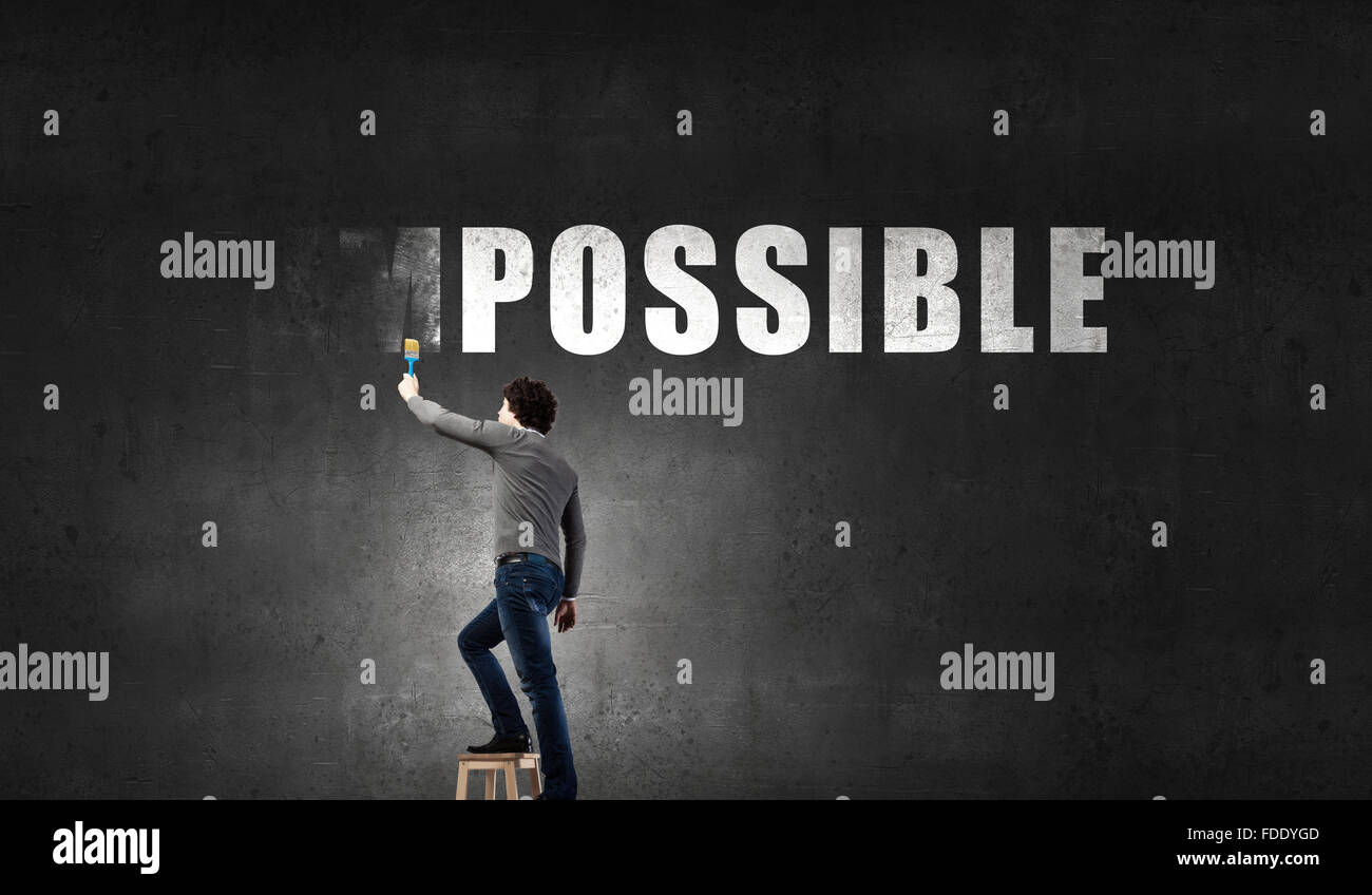 Man changing word impossible in to possible by erasing part of word ... Man changing word impossible in to possible by erasing part of word ...