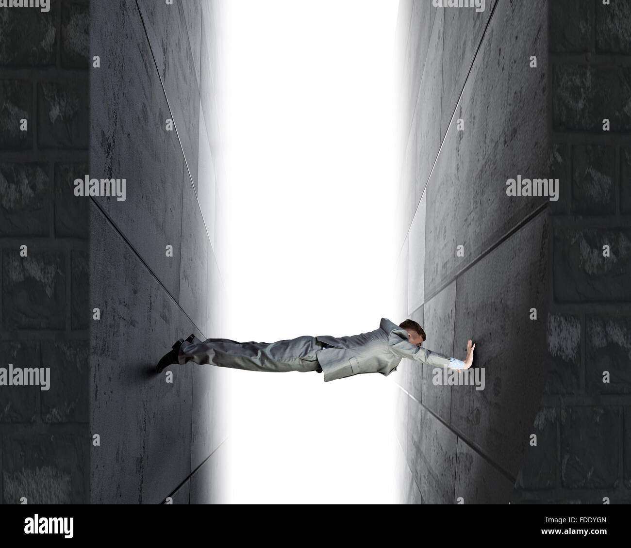 Young troubled businessman trapped between two walls Stock Photo - Alamy