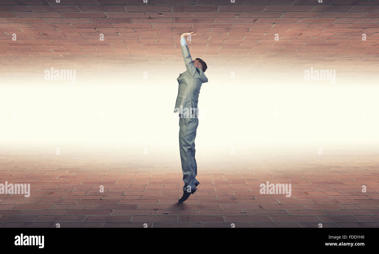 Young troubled businessman trapped between two walls Stock Photo - Alamy