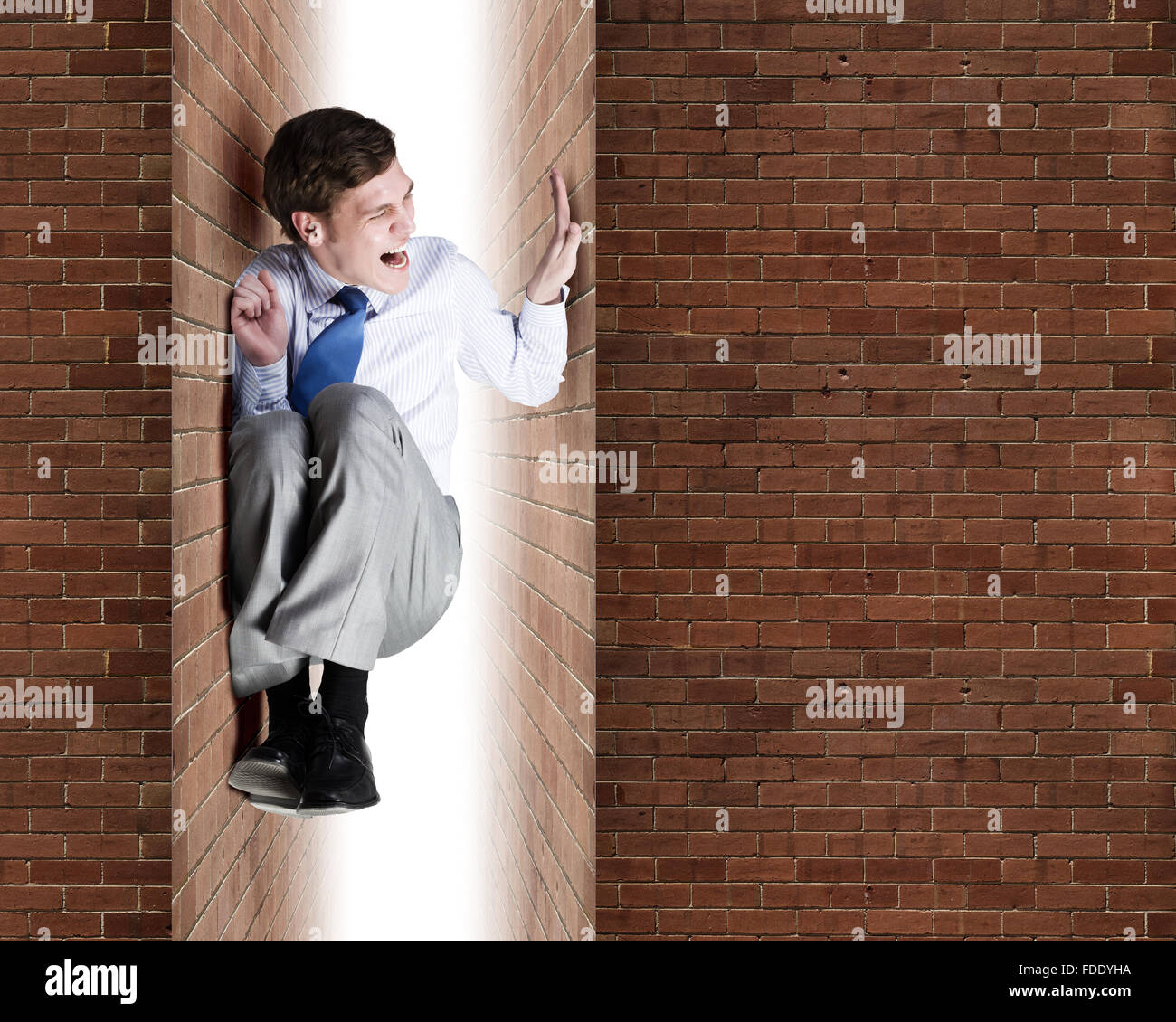 Young troubled businessman trapped between two walls Stock Photo - Alamy