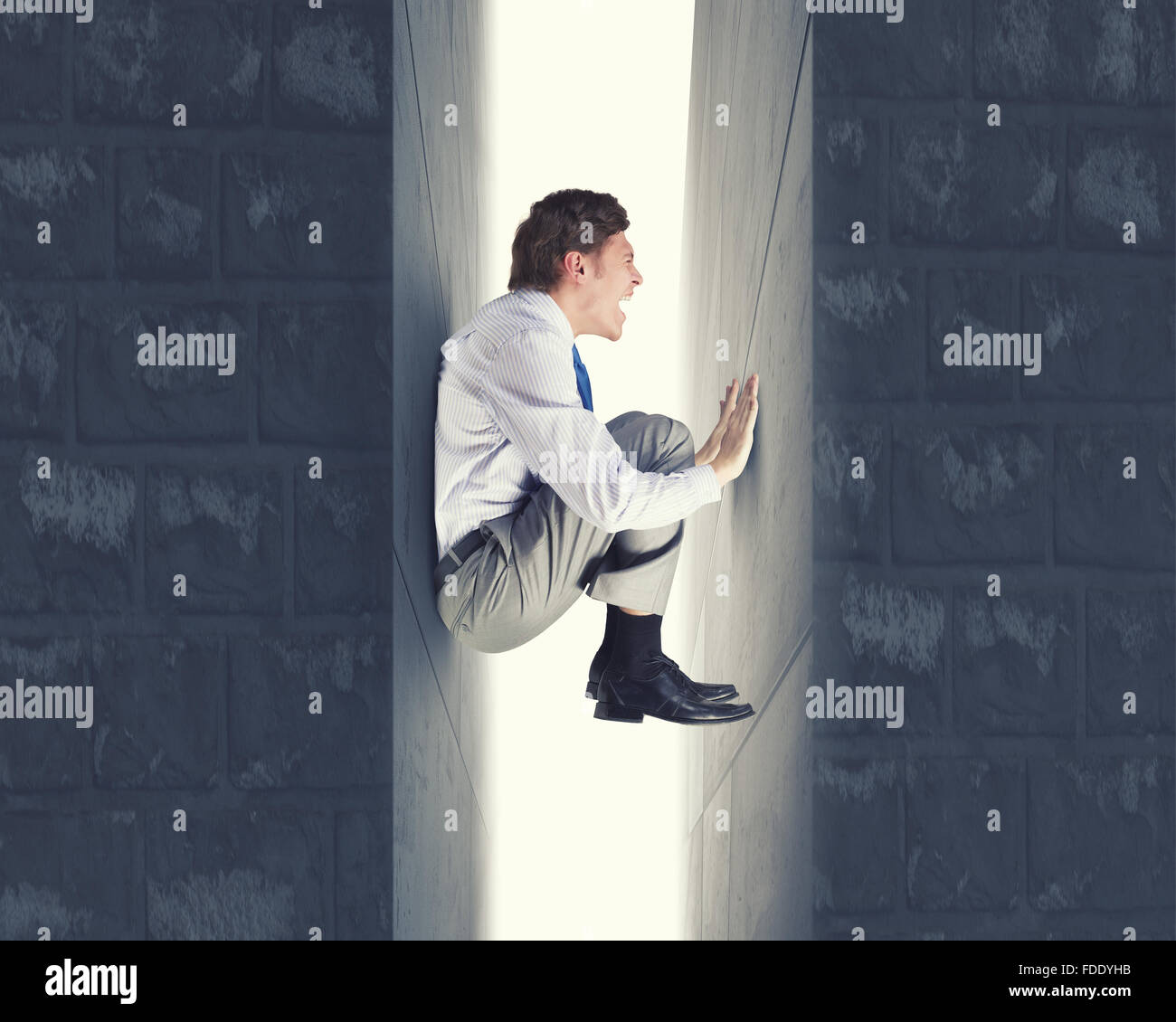 Young troubled businessman trapped between two walls Stock Photo - Alamy