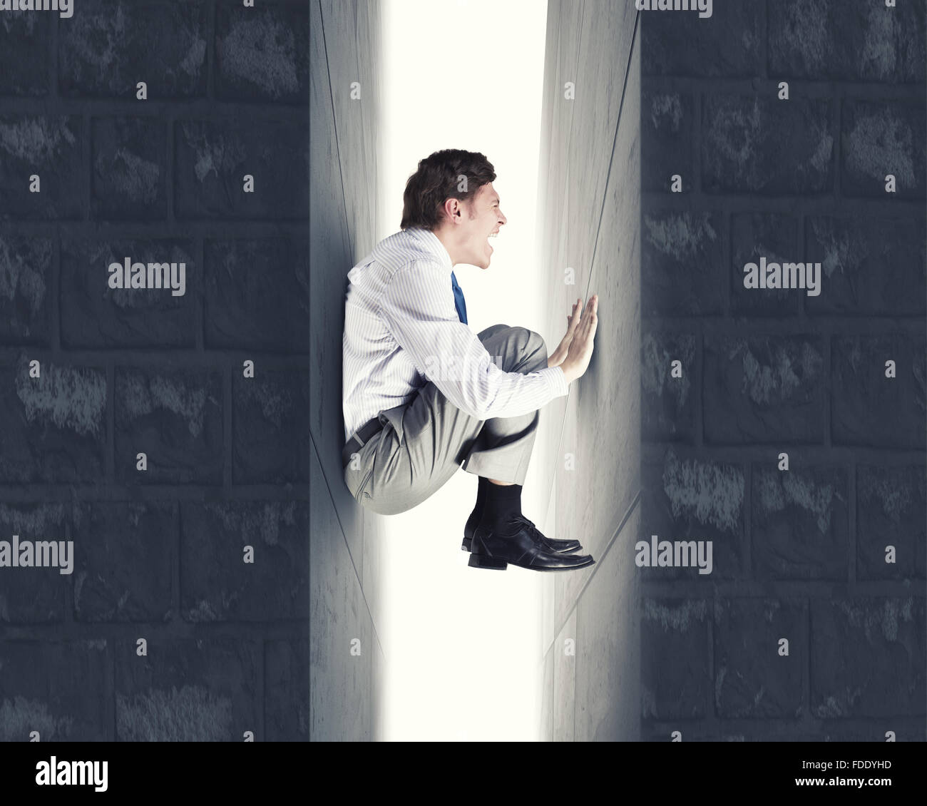 Young troubled businessman trapped between two walls Stock Photo - Alamy