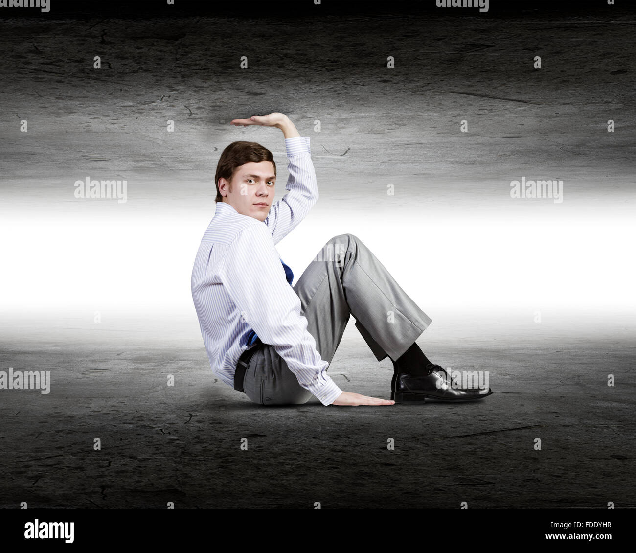 Young troubled businessman trapped between two walls Stock Photo - Alamy