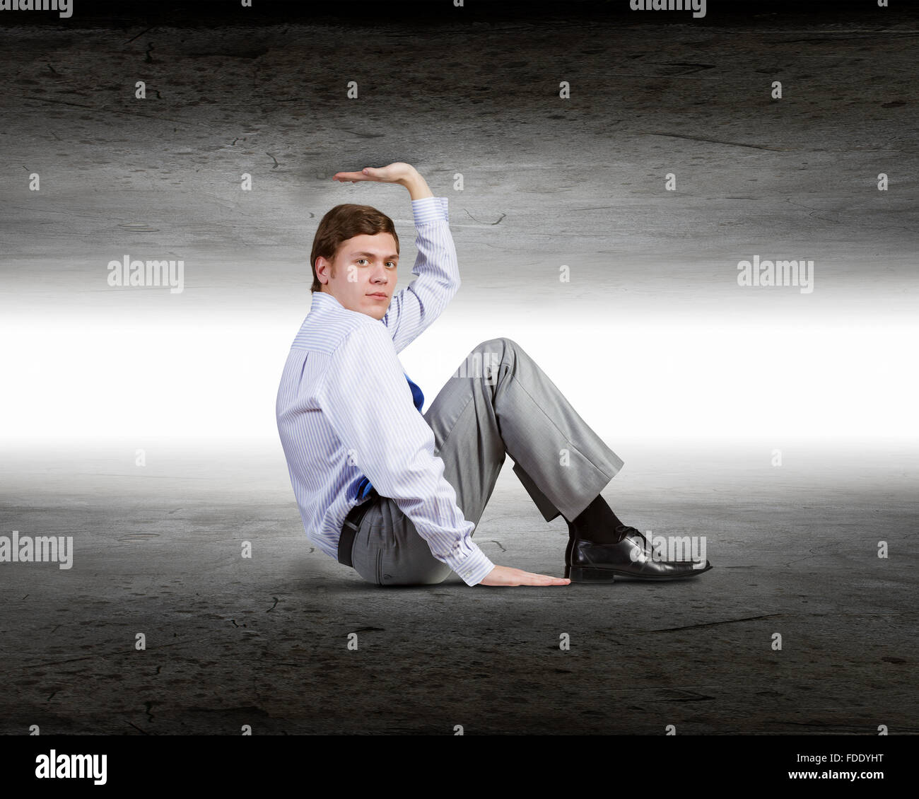 Young troubled businessman trapped between two walls Stock Photo - Alamy