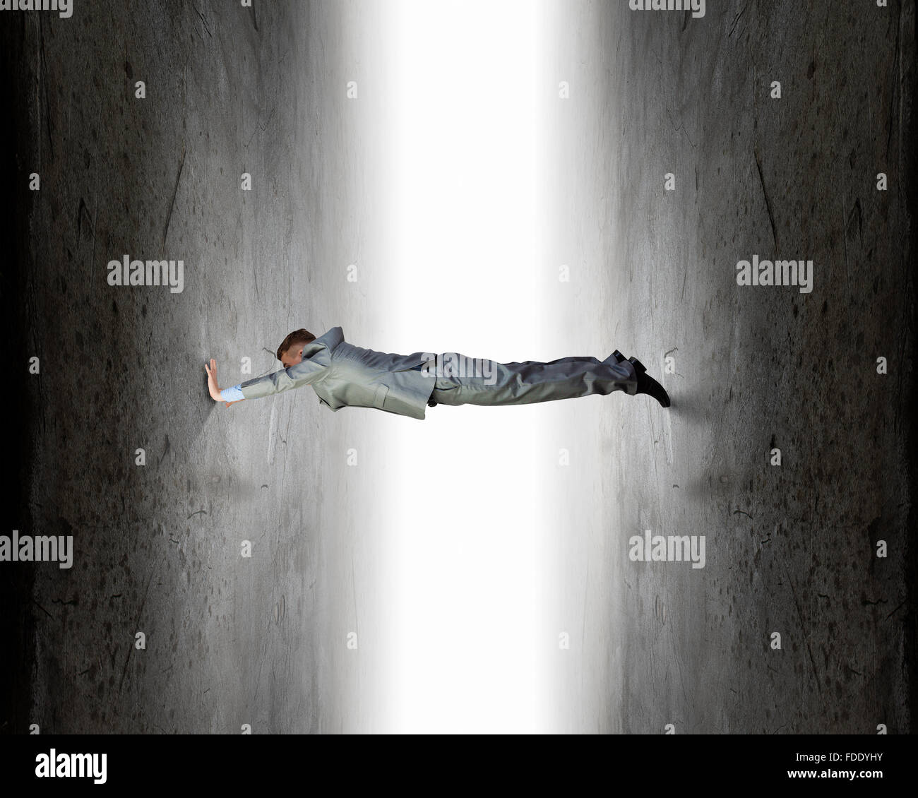 Young troubled businessman trapped between two walls Stock Photo - Alamy