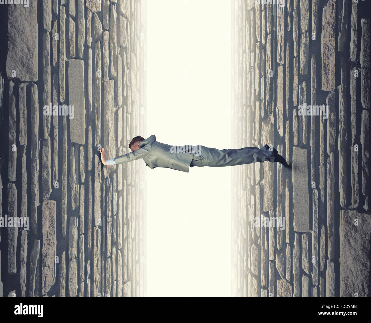 Young troubled businessman trapped between two walls Stock Photo - Alamy