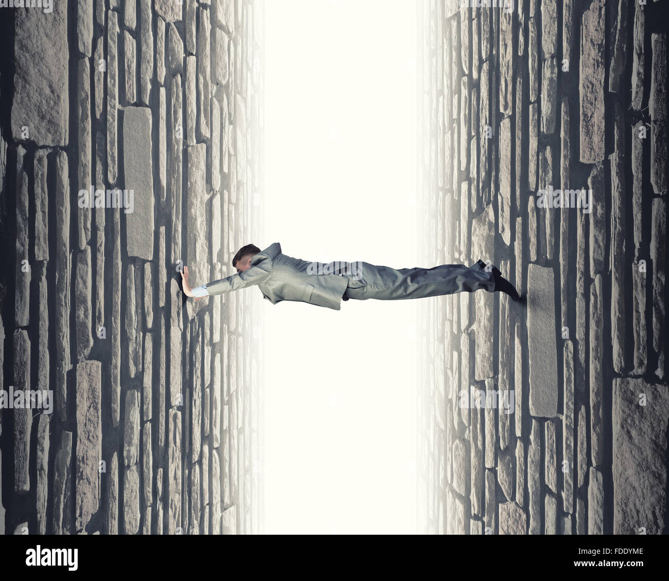 Young troubled businessman trapped between two walls Stock Photo - Alamy