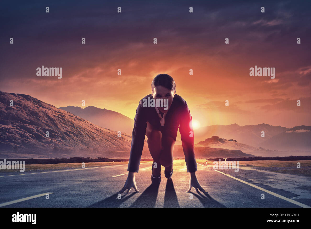 Young determined businesswoman standing in start position Stock Photo ...