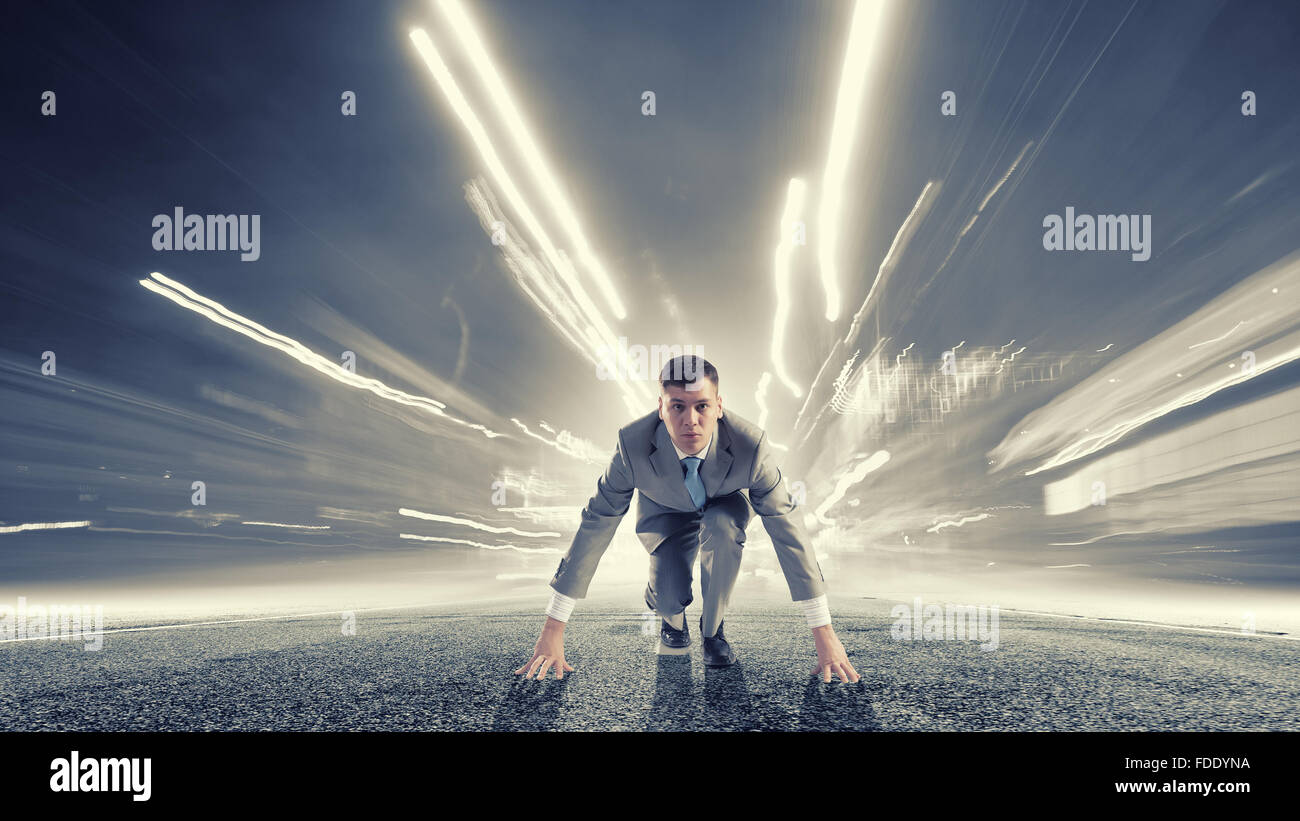 Young determined businessman standing in start position Stock Photo - Alamy