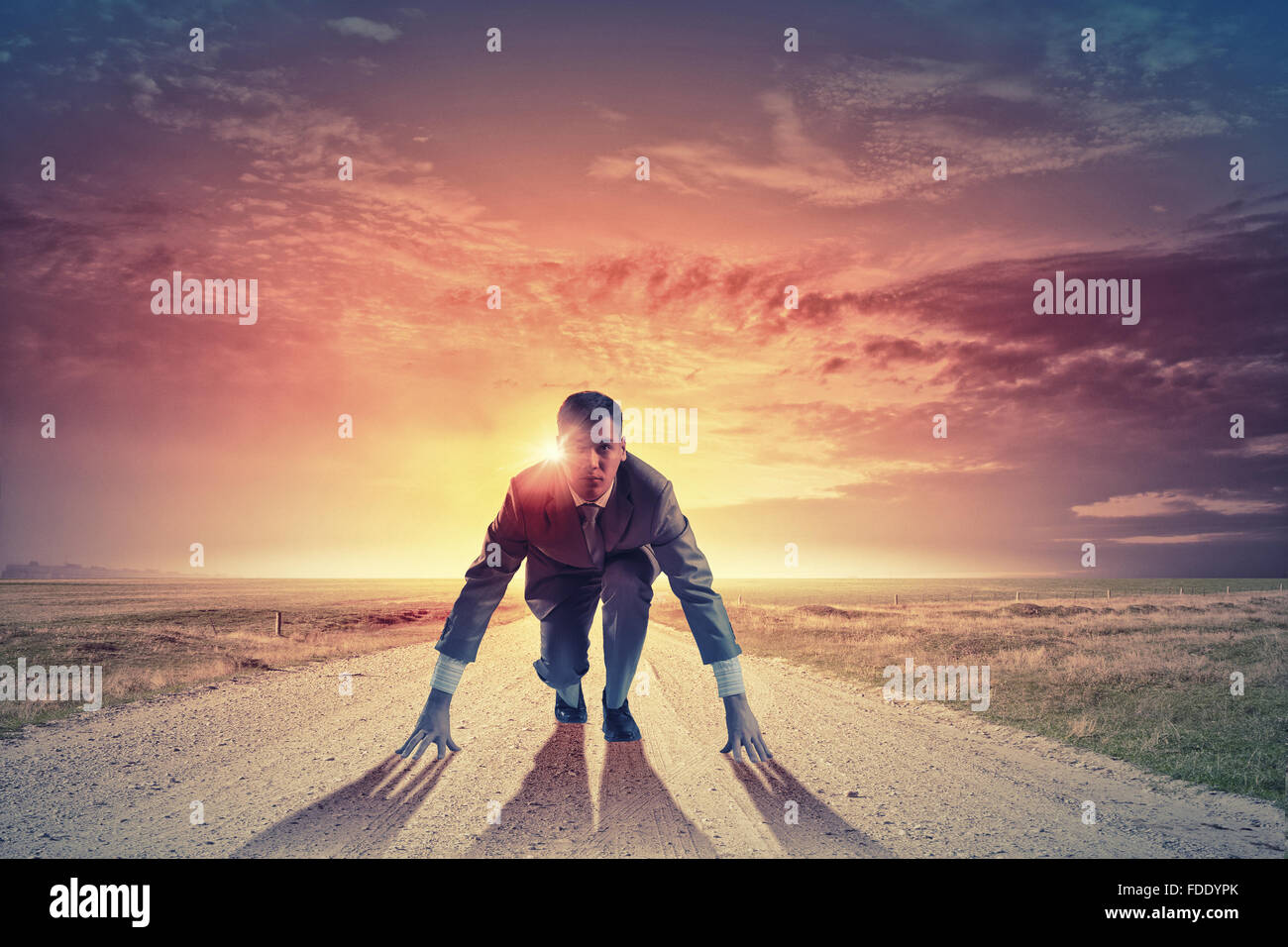 Young determined businessman standing in start position Stock Photo - Alamy