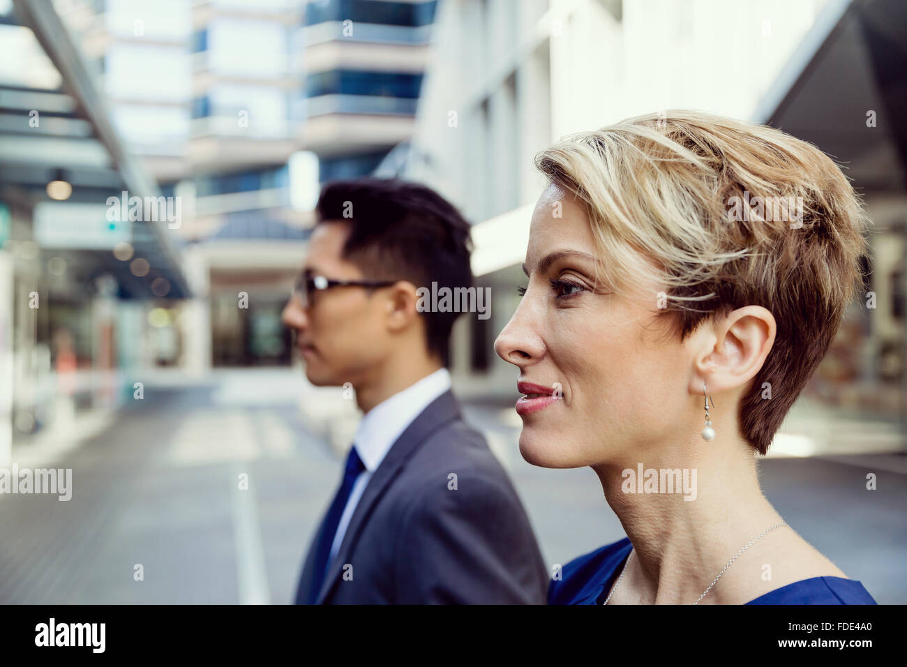 Businessteam members standing next to each other in business district ...