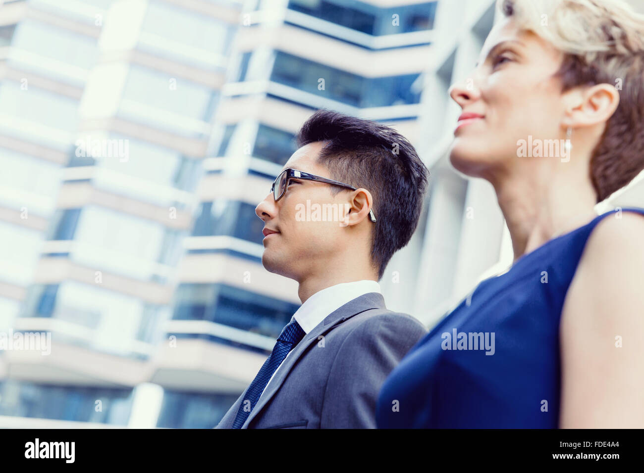 Business team members standing next to each other in business district ...