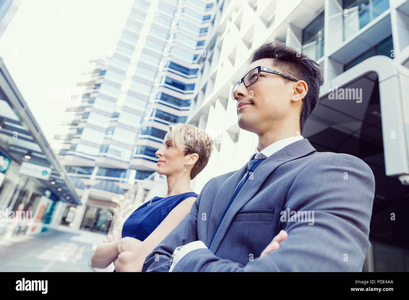 Business team members standing next to each other in business district ...