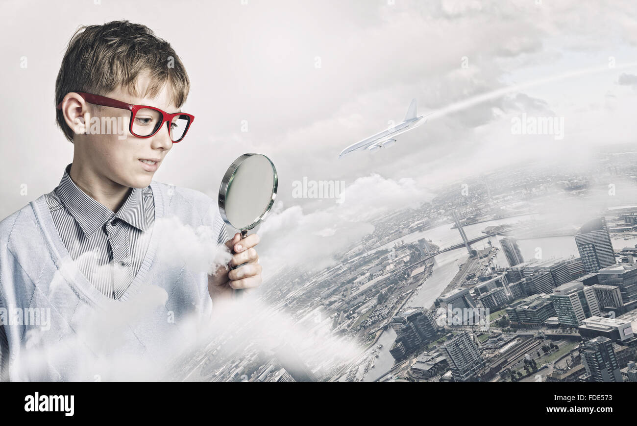 Cute school boy examining objects with magnifying glass Stock Photo - Alamy