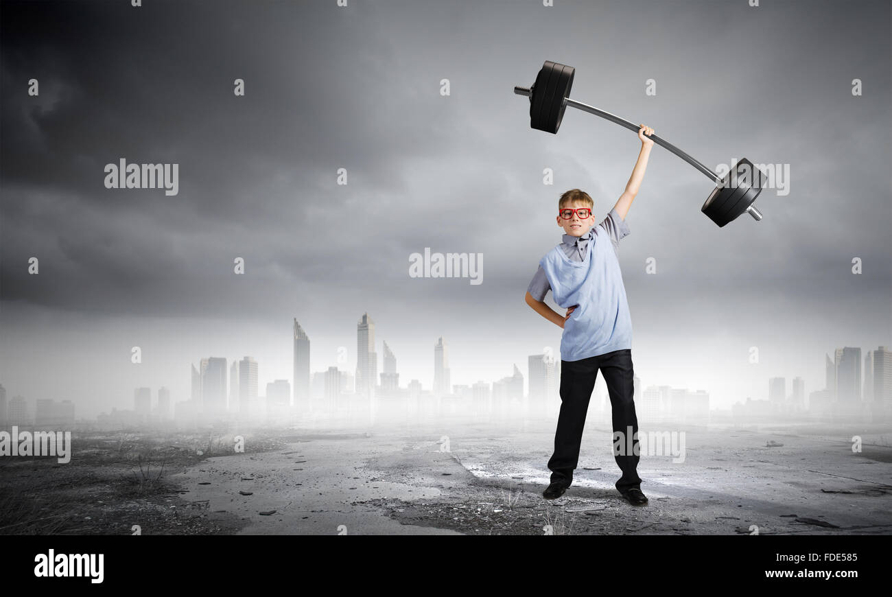Cute boy of school age lifting barbell above head Stock Photo - Alamy