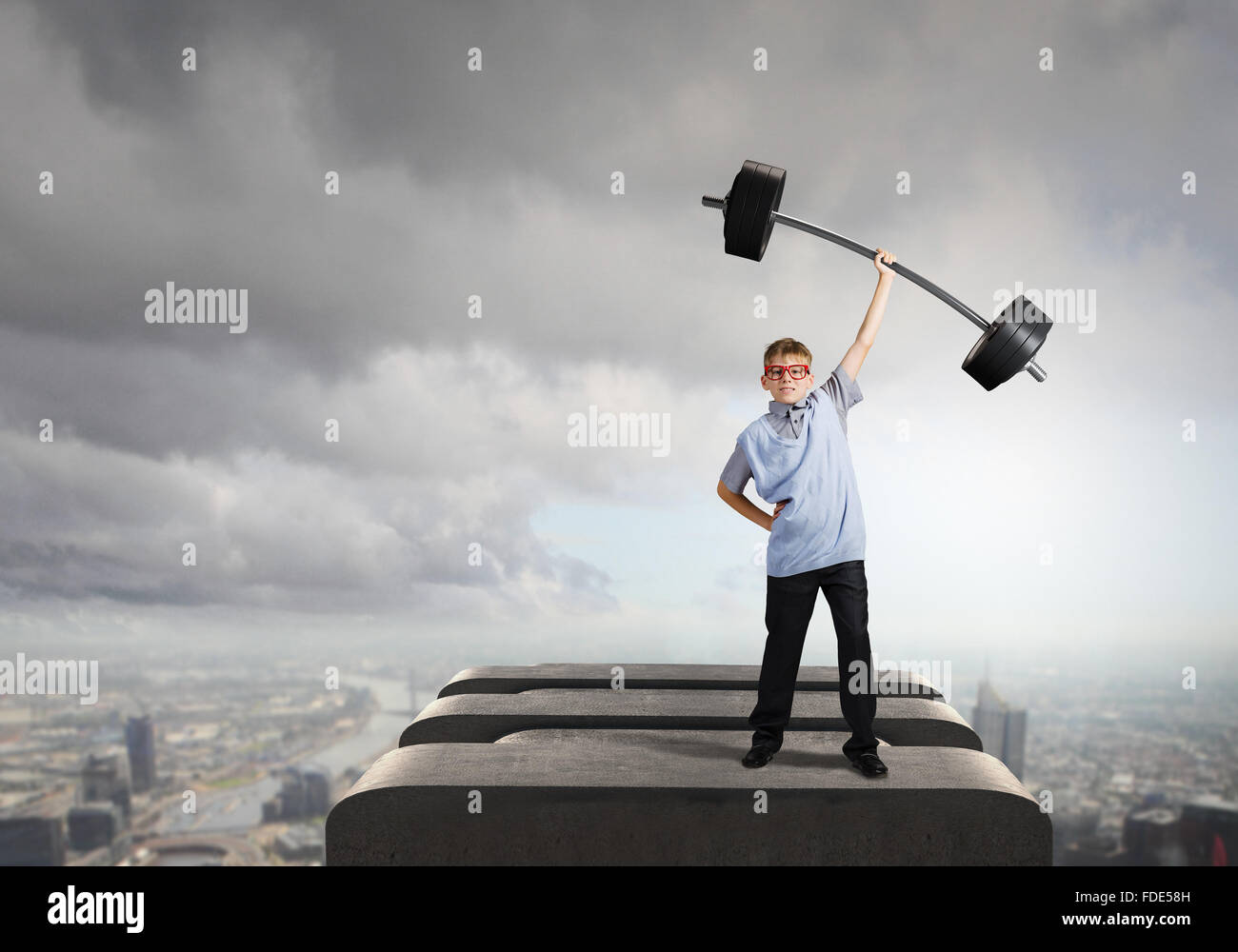 Cute boy of school age lifting barbell above head Stock Photo - Alamy
