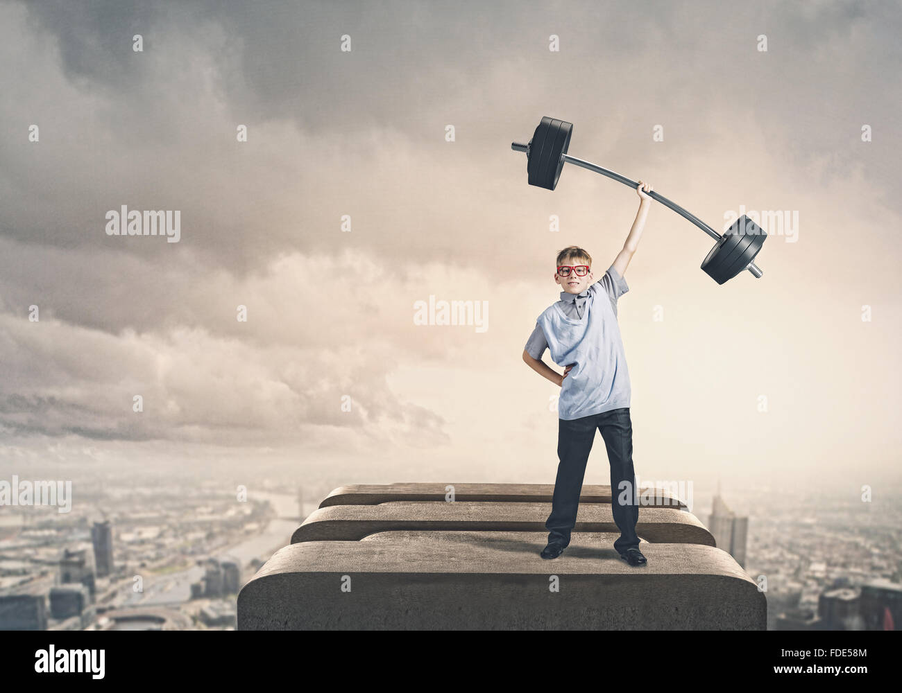 Cute boy of school age lifting barbell above head Stock Photo - Alamy