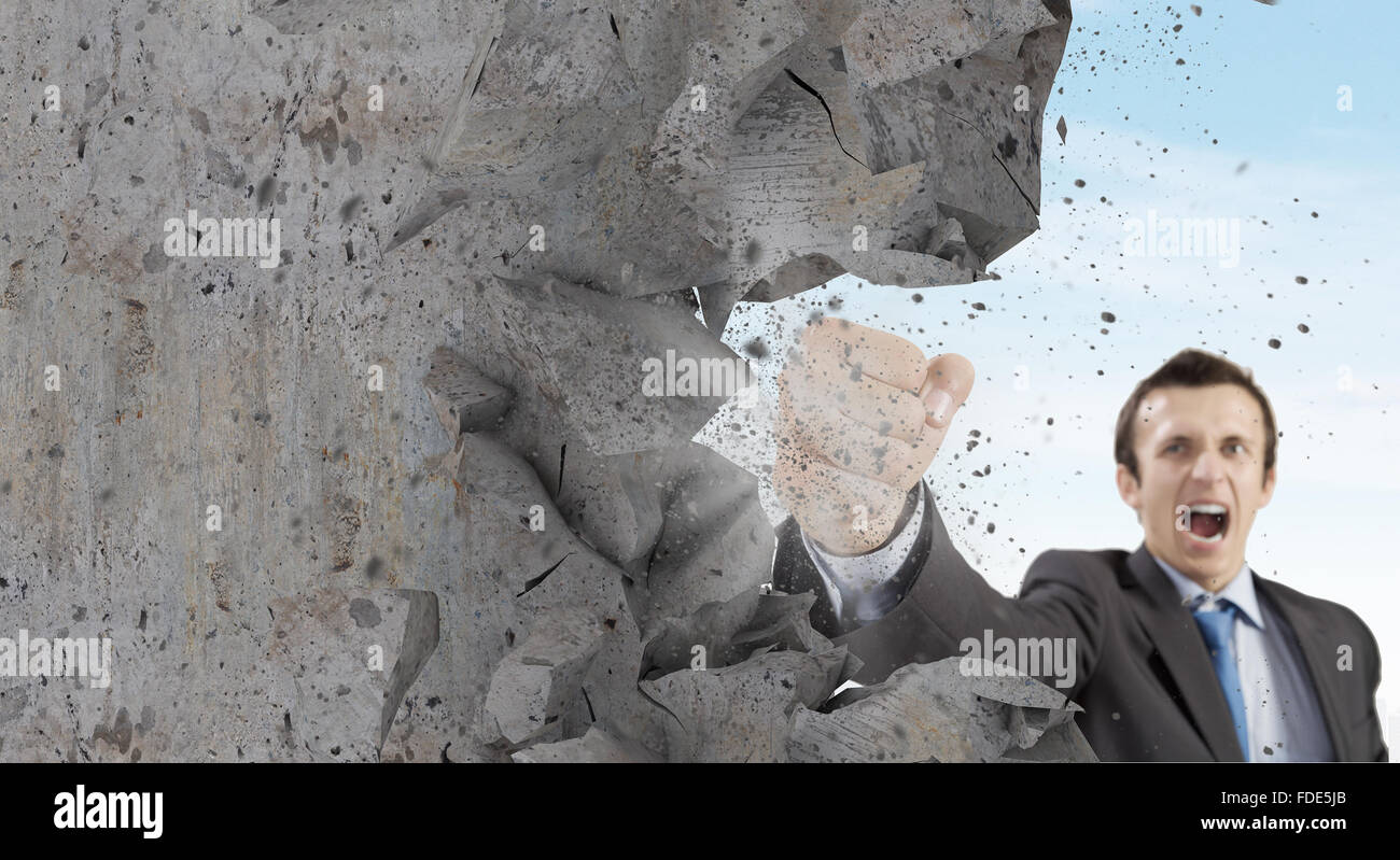 Businessman breaking stone wall with karate punch Stock Photo - Alamy