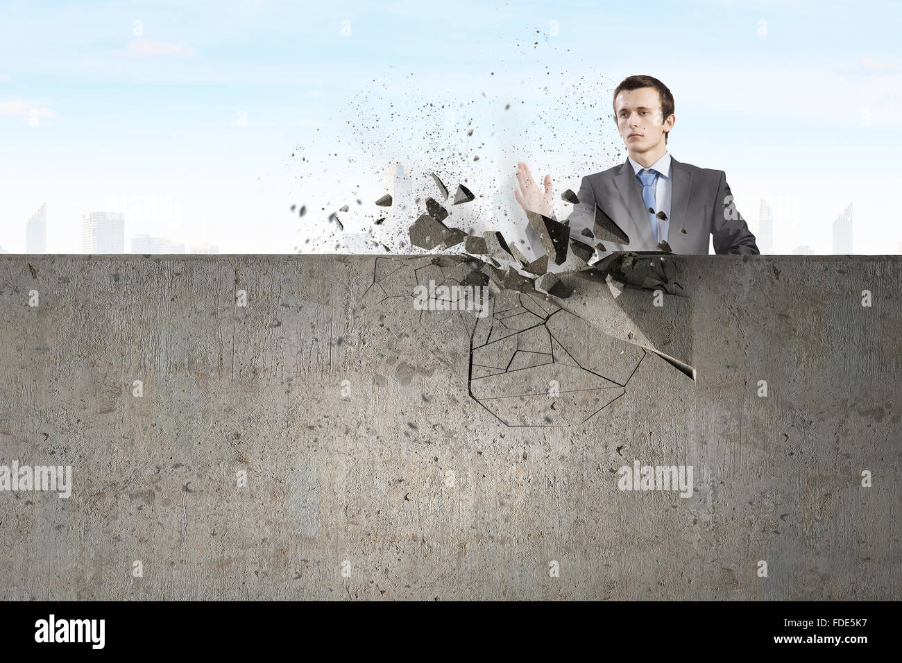 Businessman breaking stone wall with karate punch Stock Photo - Alamy