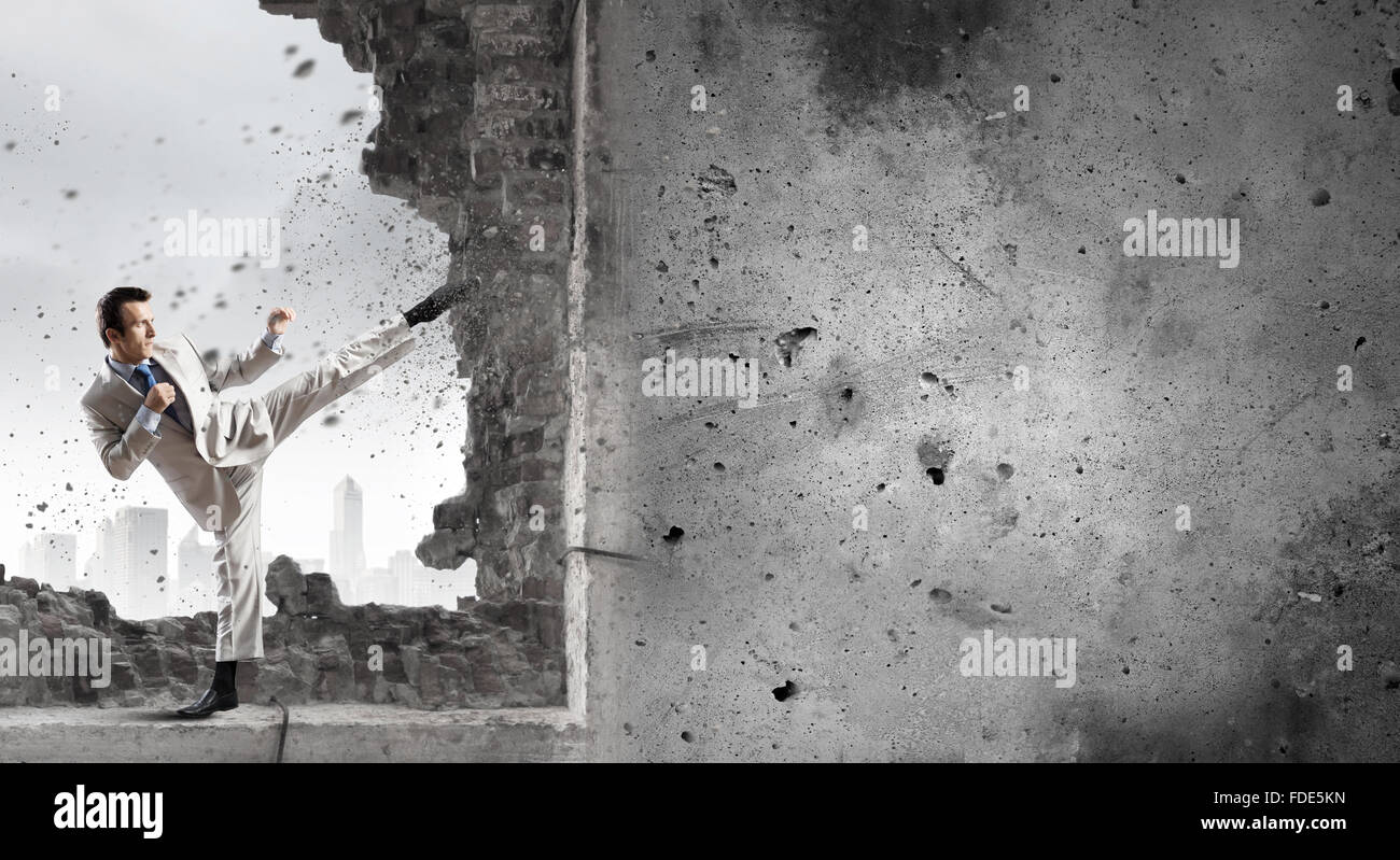 Businessman breaking stone wall karate hi-res stock photography and ...