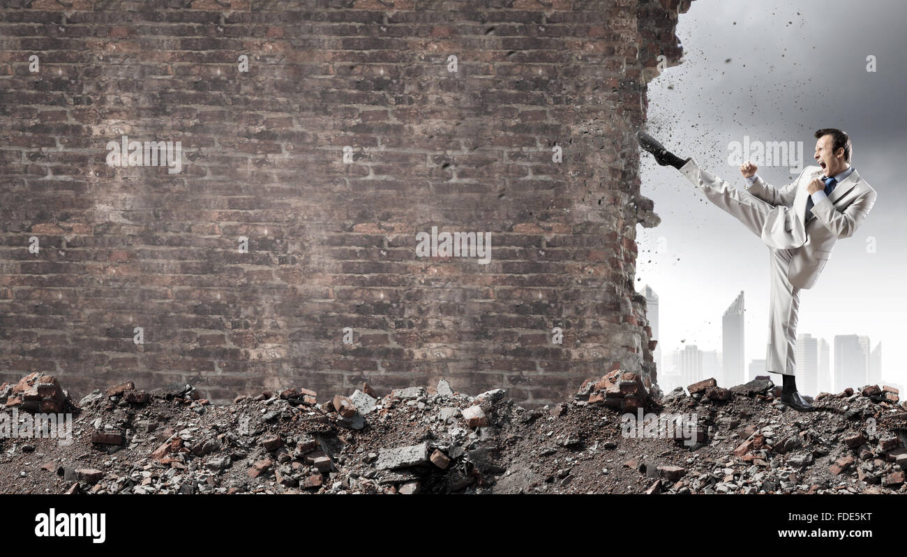 Businessman breaking stone wall karate hi-res stock photography and ...
