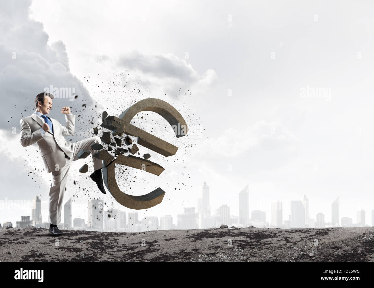 Businessman breaking stone euro symbol with karate kick Stock Photo - Alamy