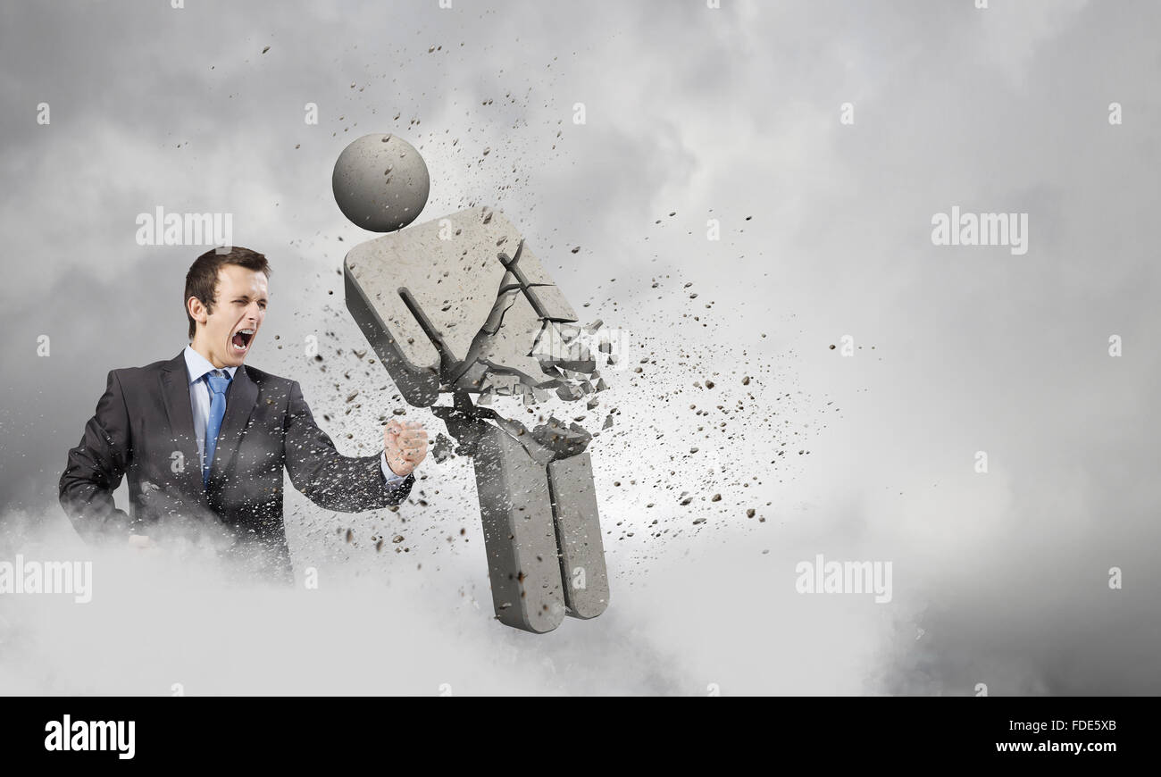 Angry young businessman fighting with stone opponent Stock Photo - Alamy