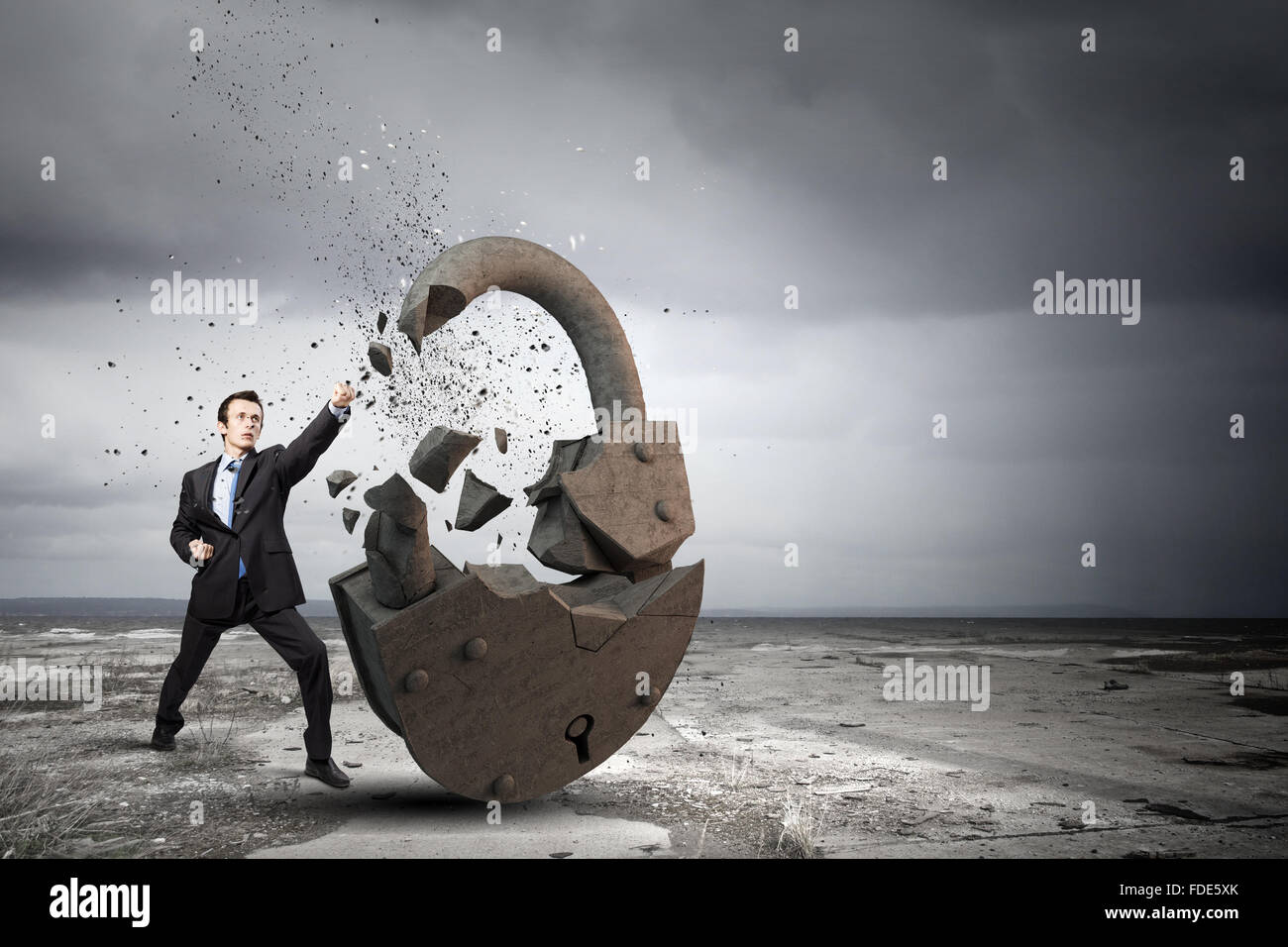 Businessman breaking stone lock with karate kick Stock Photo - Alamy