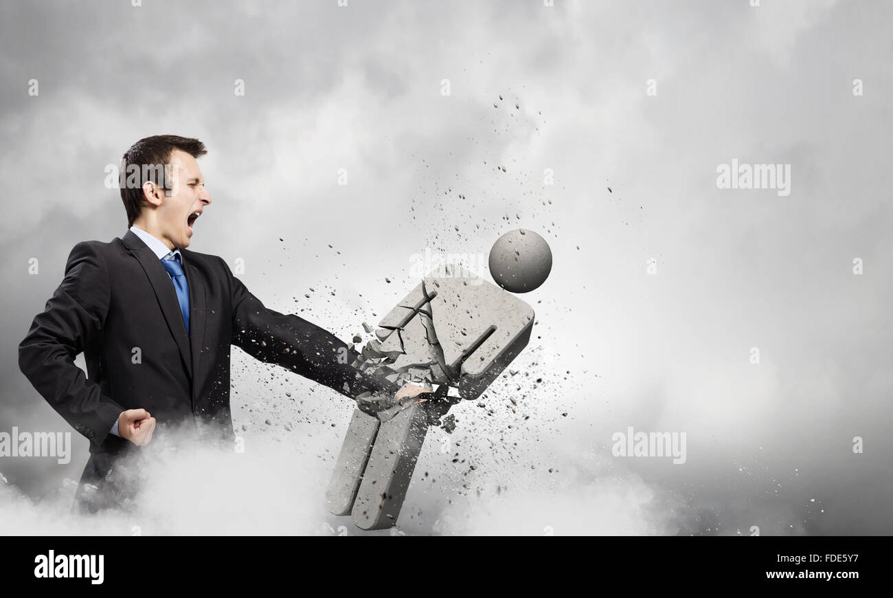 Angry young businessman fighting with stone opponent Stock Photo - Alamy