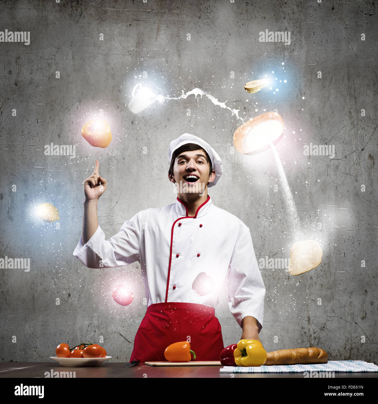 Young cheerful cook and ingredients flying in air Stock Photo - Alamy