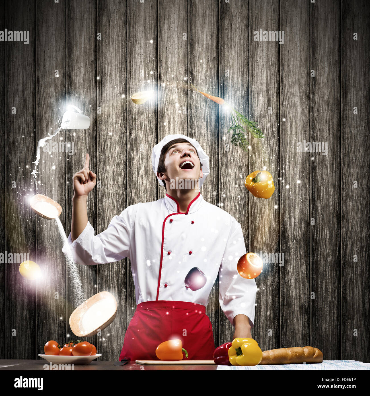 Young man at kitchen juggling with ingredients Stock Photo - Alamy