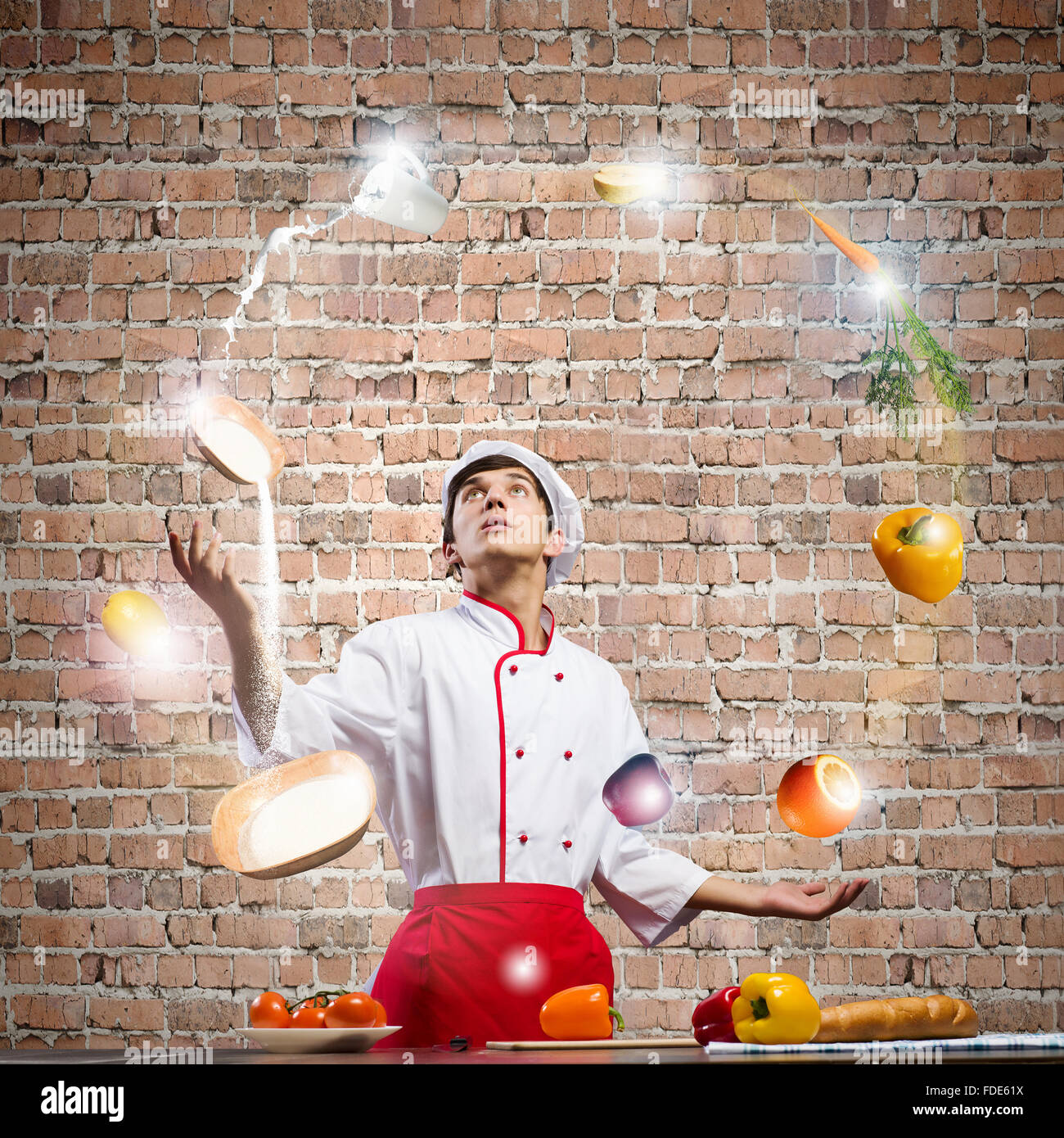 Young man at kitchen juggling with ingredients Stock Photo - Alamy