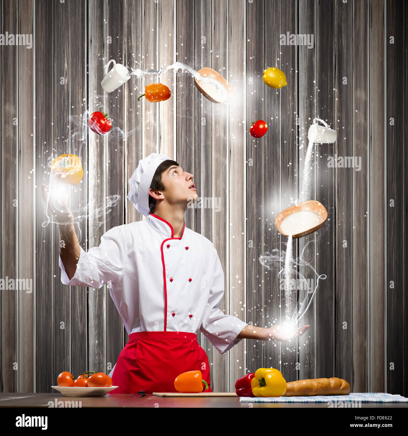 Young man at kitchen juggling with ingredients Stock Photo - Alamy