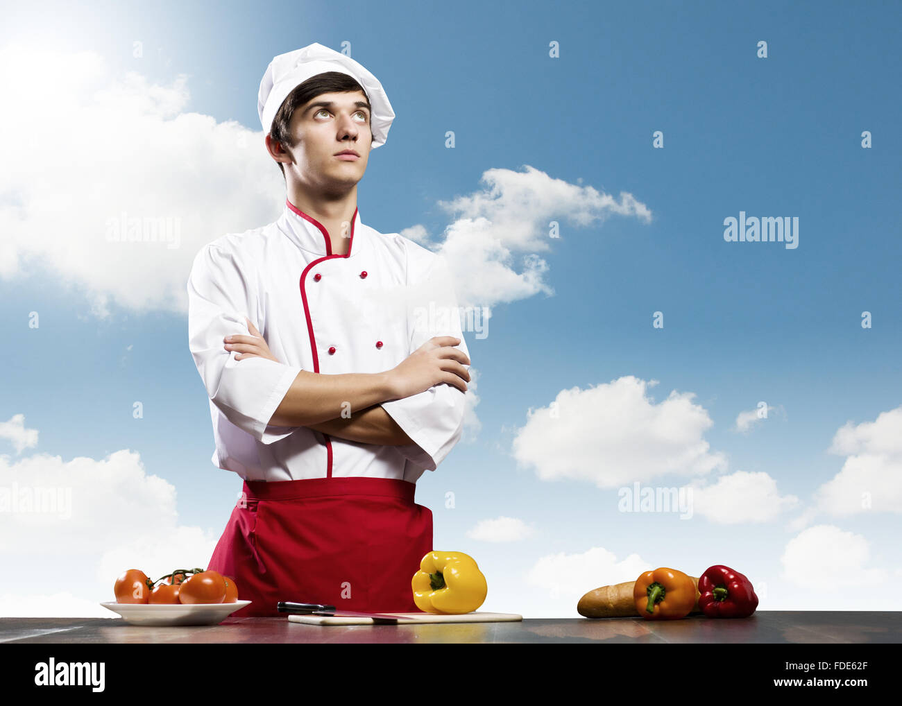 Young cheerful cook and ingredients flying in air Stock Photo - Alamy
