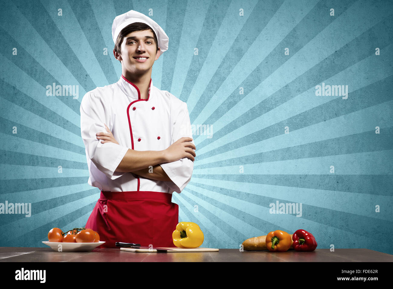 Young cheerful cook and ingredients flying in air Stock Photo - Alamy