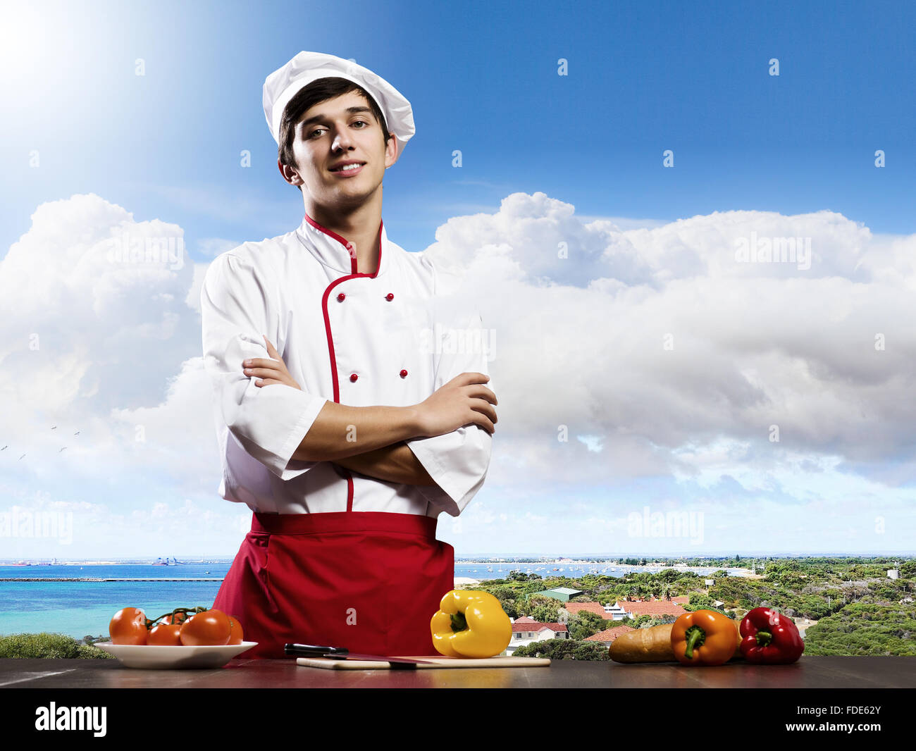 Young cheerful cook and ingredients flying in air Stock Photo - Alamy