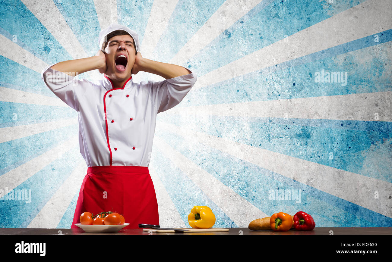 Young screaming cook and vegetables on table hi-res stock photography ...