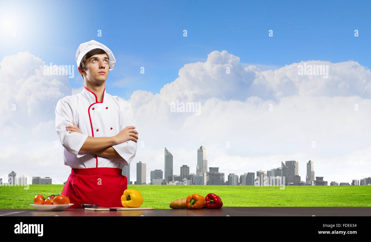 Young cheerful cook and ingredients flying in air Stock Photo - Alamy