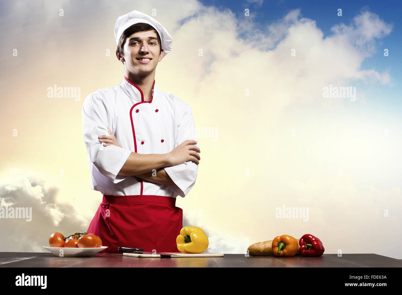 Young cheerful cook and ingredients flying in air Stock Photo - Alamy